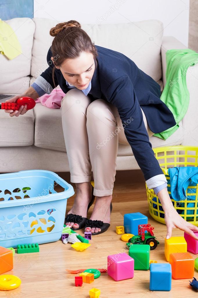 Lady cleaning up toys Stock Photo by ©photographee.eu 48284741