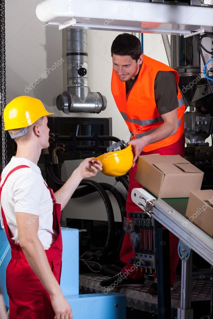 Men taking care about safety at warehouse Stock Photo by ©photographee ...