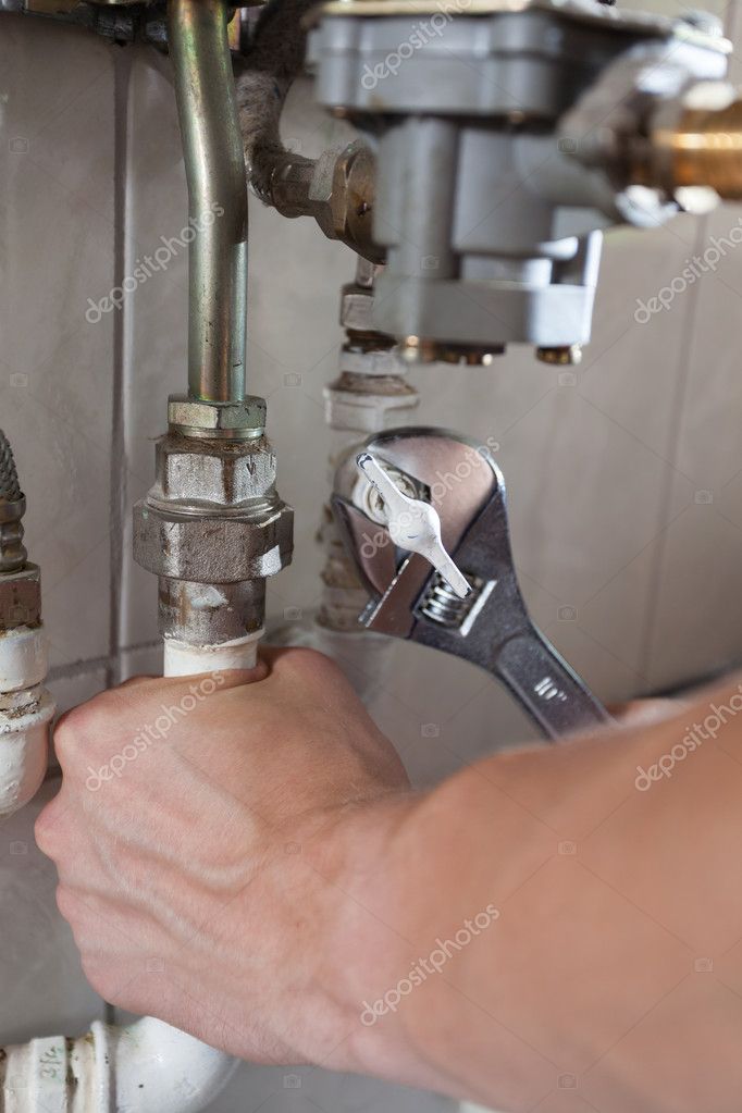 Hands using wrench at work Stock Photo by ©photographee.eu 51487573
