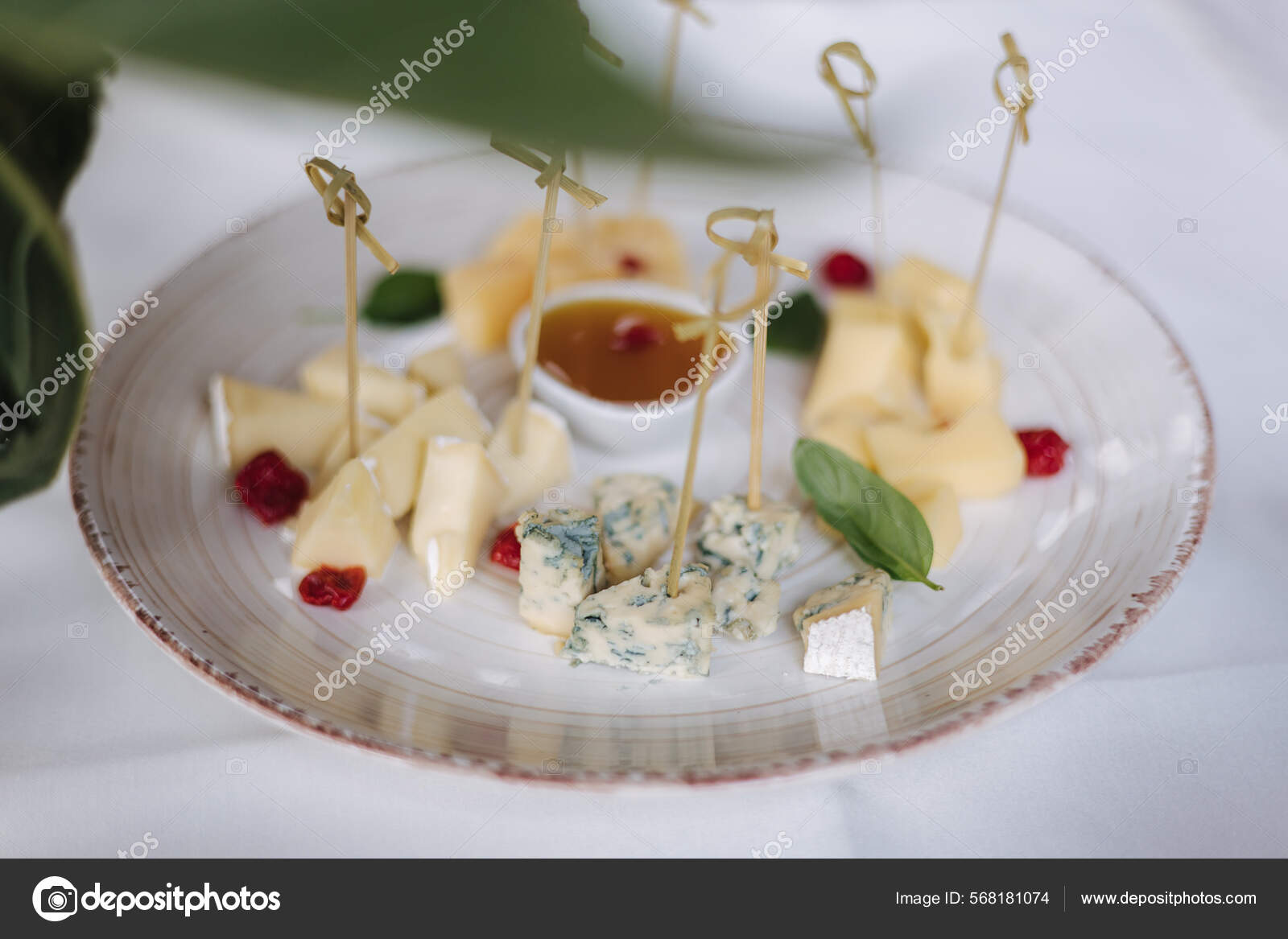 Four different types of cheere on a handmade plate. Bamboo toothpicks ...