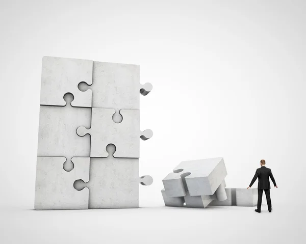 Man constructing puzzle Stock Photo by ©kantver 27729707