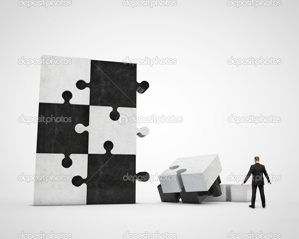 Man constructing puzzle Stock Photo by ©kantver 27729707