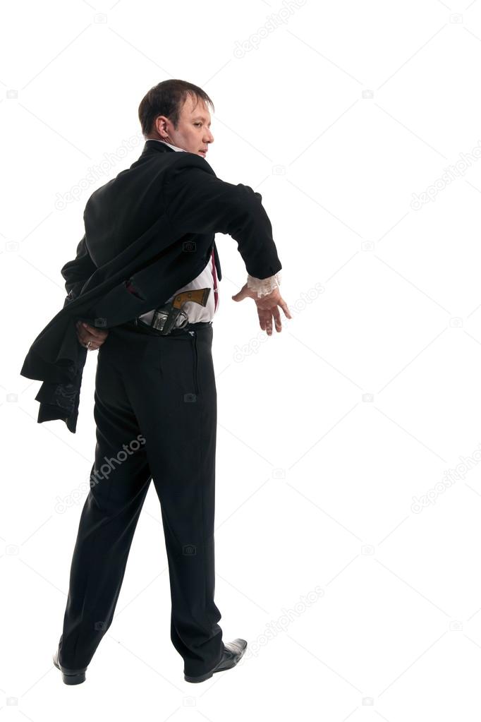 Man holding a gun behind his back Stock Photo by ©sdigitall 47117499