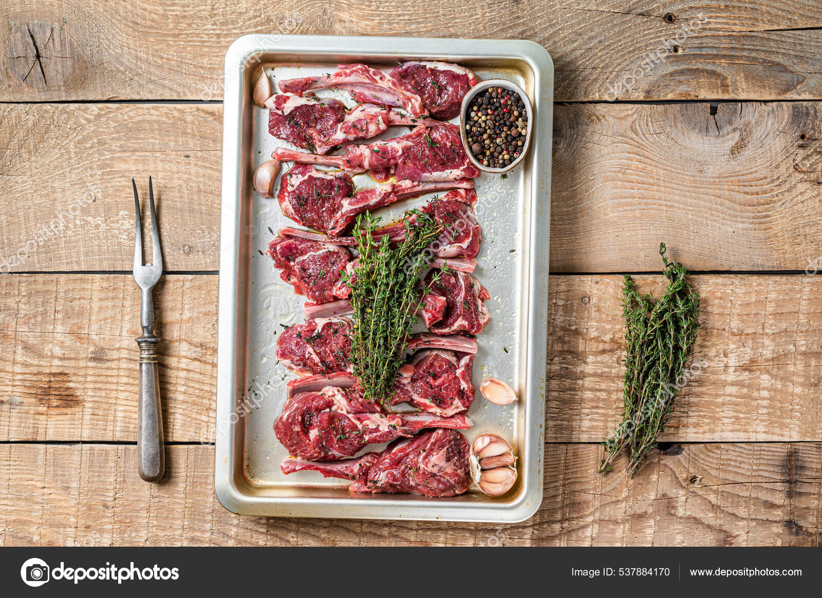 Raw uncooked lamb mutton meat chops steaks with thyme and garlic ...