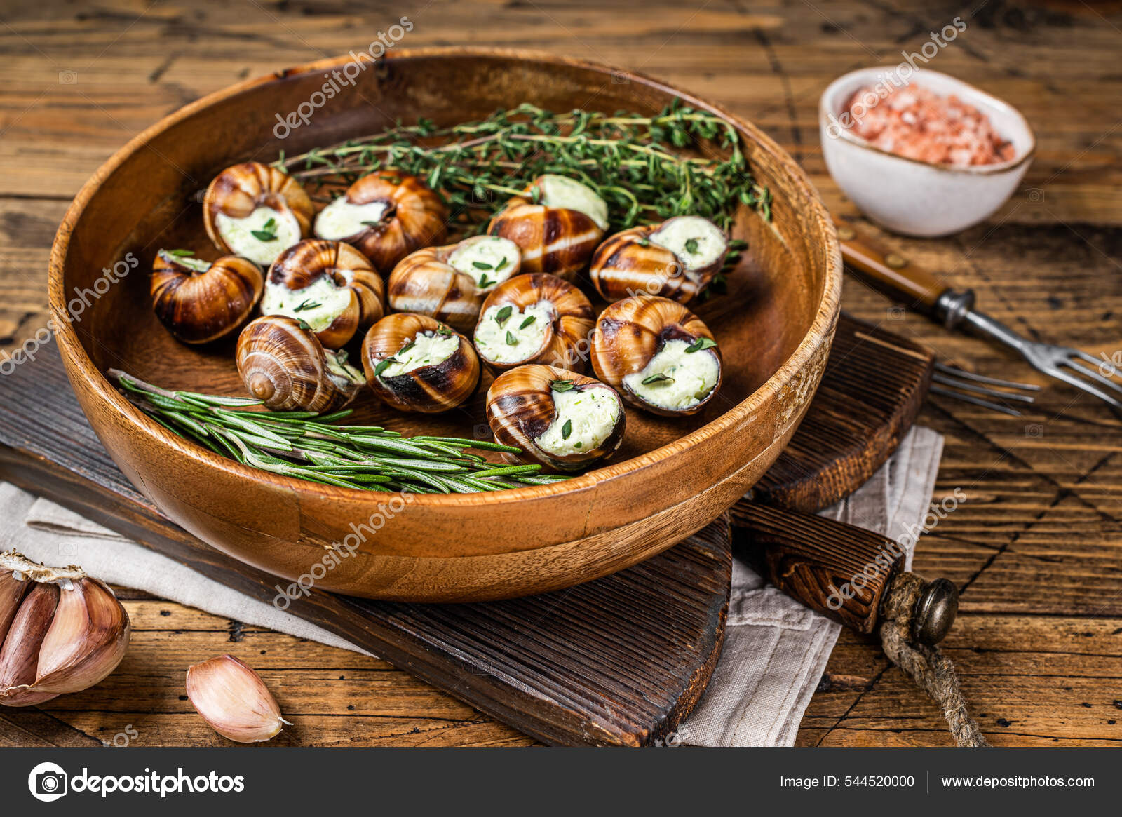 French Escargot Snails with garlic butter in a wooden plate. Wooden ...