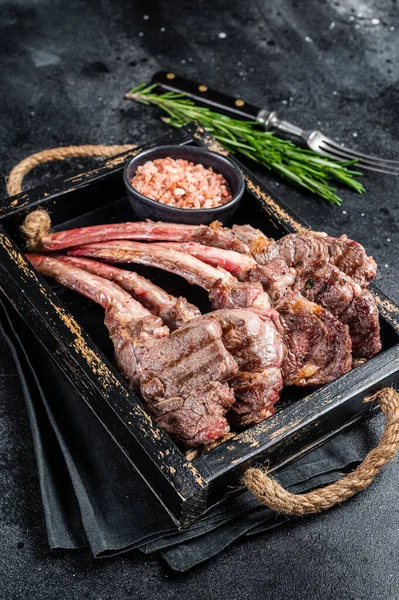 Grilled lamb chop steak, mutton meat cutlet in wooden tray. Black ...