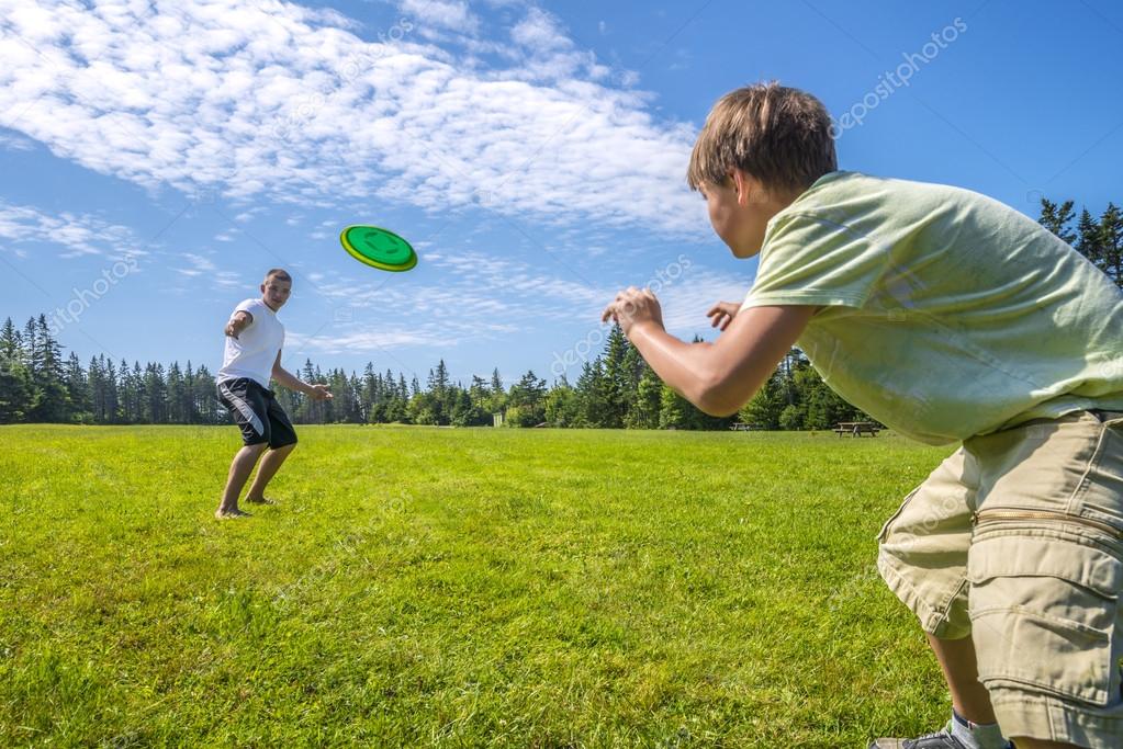 Boys playing a frisbee Stock Photo by ©VadimPetrov 29862535
