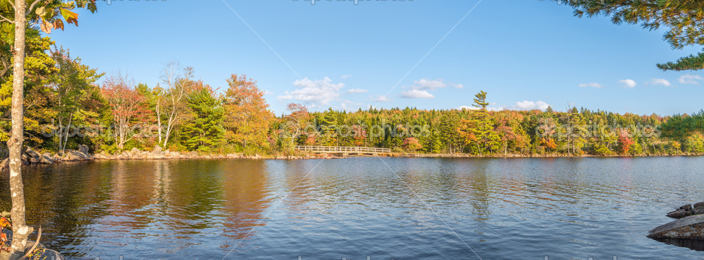 Idyllic fall foliage scene with reflections on lake Stock Photo by ...