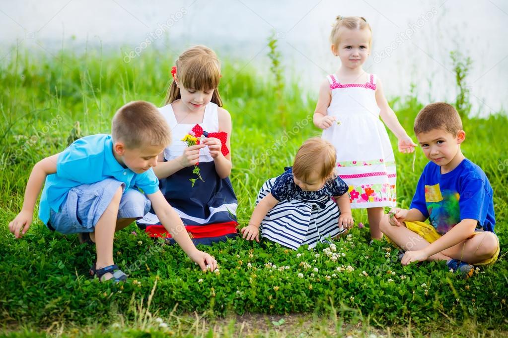 Childrens playing in spring filed — Stock Photo © HannaNes #29215679