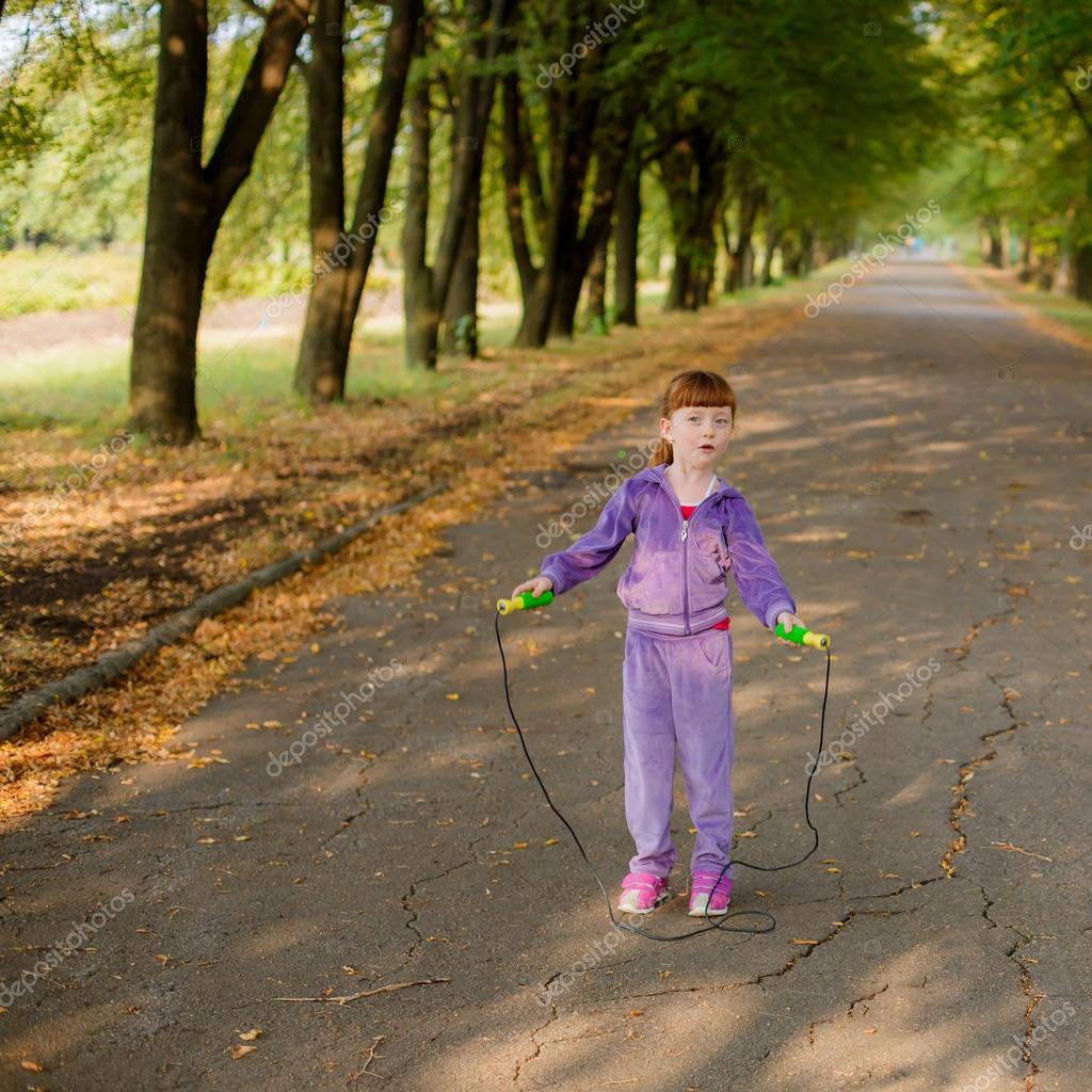 Girl jumping on a skipping rope — Stock Photo © HannaNes #31276393
