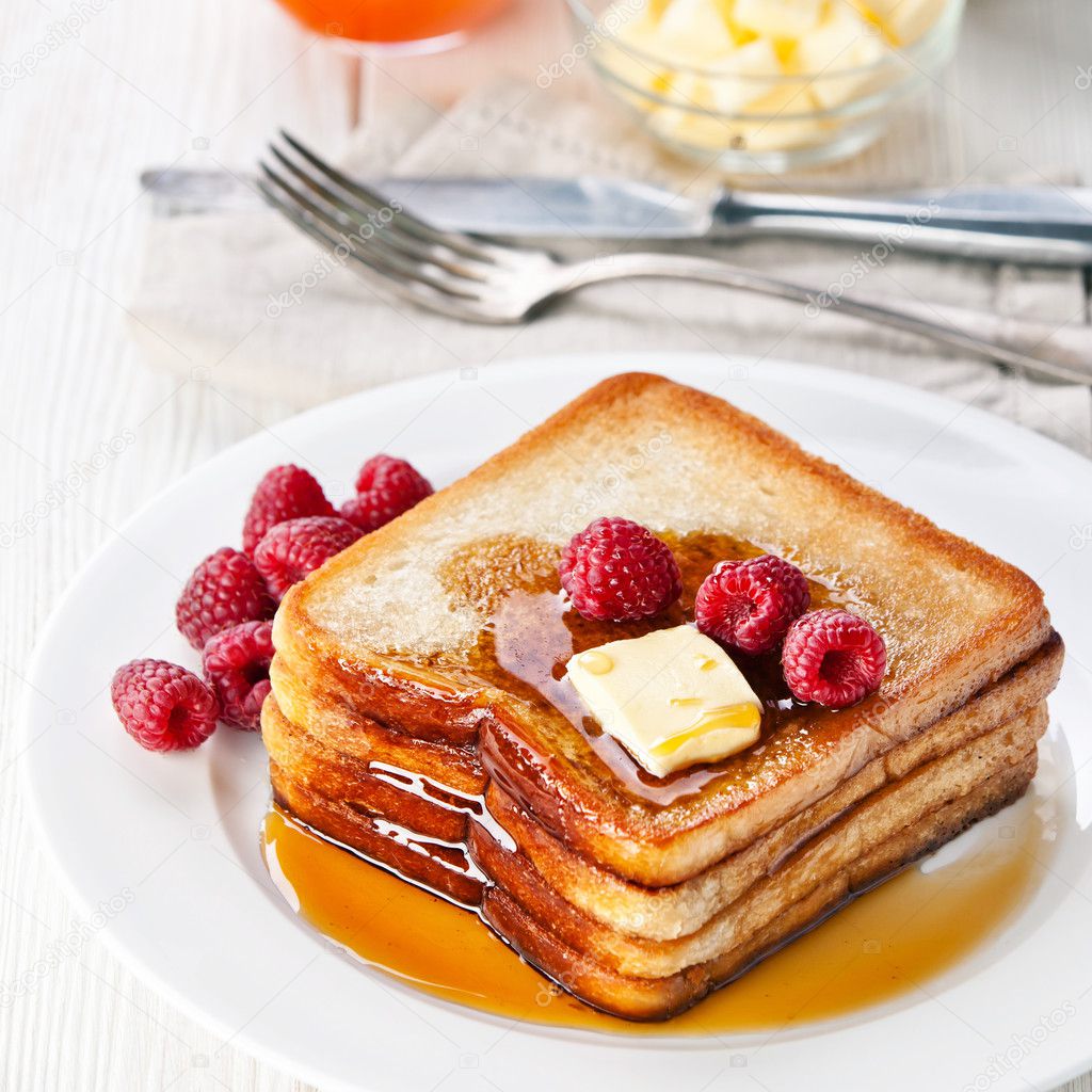 French toast with raspberries, maple syrup and butter — Stock Photo ...