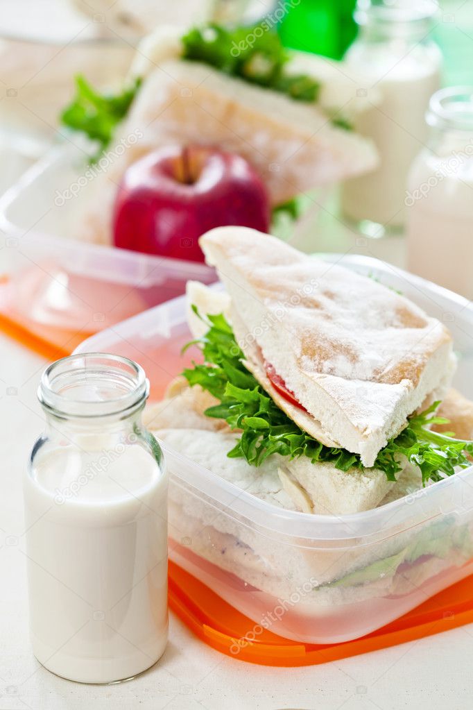 Lunch box with sandwich, apple and milk Stock Photo by ©lisovskaya 24484257
