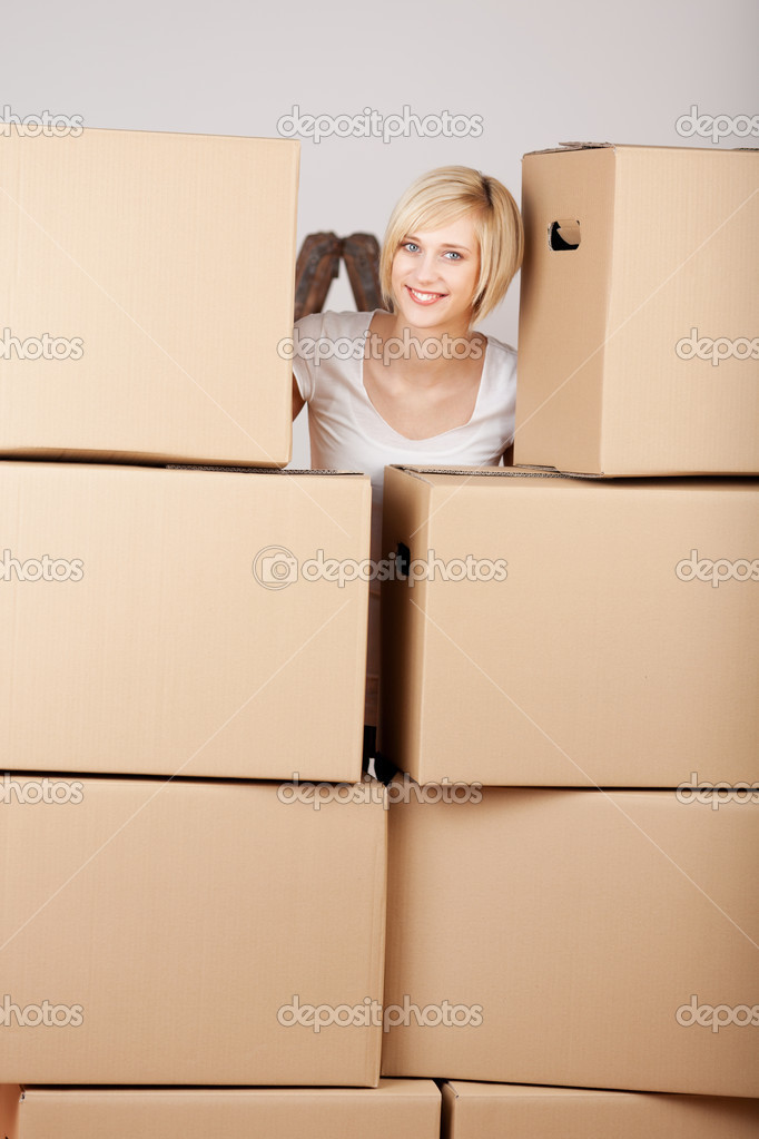 Woman Behind Stack Of Cardboard Boxes Stock Photo by ©racorn 26007699