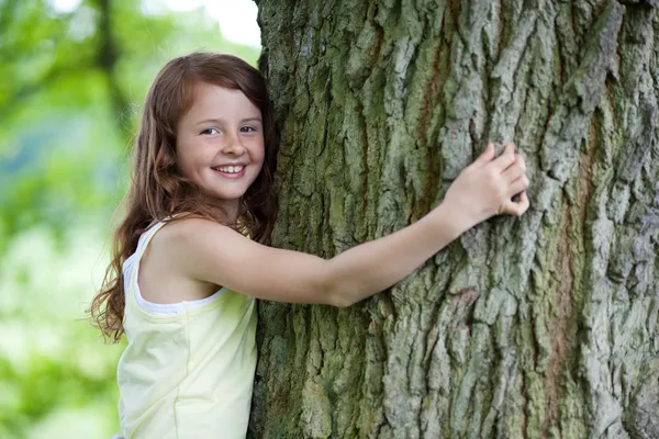 Little boy embracing big tree in the forest — Stock Photo © racorn ...