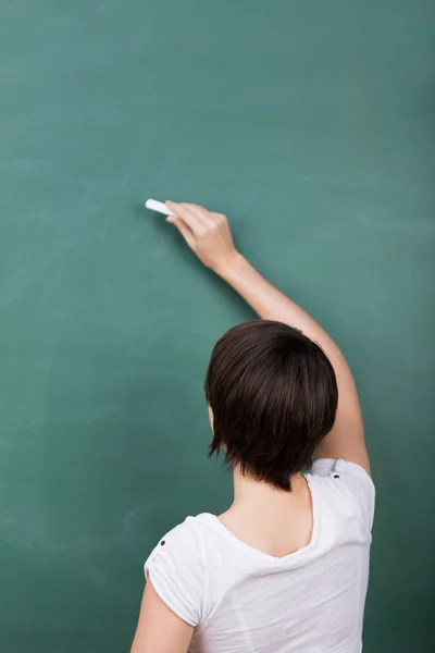 Student Writing On Chalkboard In Classroom Stock Photo by ©racorn 28076135
