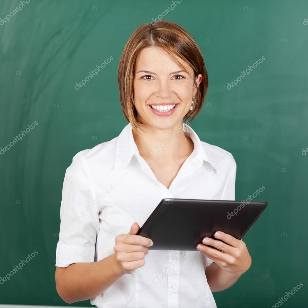 Smiling confident teacher with a tablet-pc — Stock Photo © racorn #26440009 Smiling confident teacher with a tablet-pc — Stock Photo © racorn #26440009