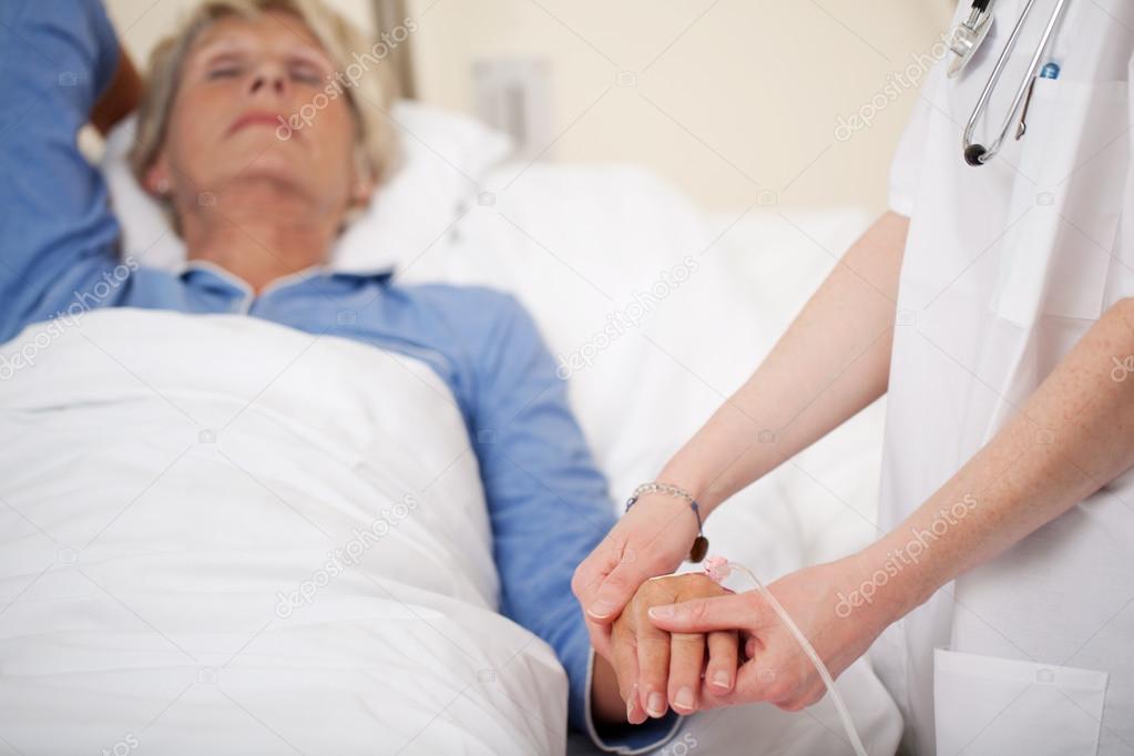 Female Doctor Checking Patients Pulse In Hospital — Stock Photo ...