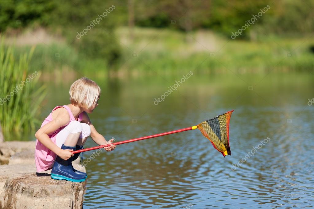 Little girl waiting for fish in at lake — Stock Photo © racorn #26615963