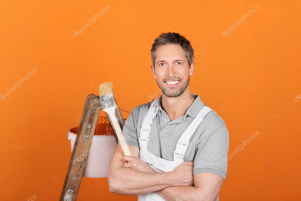 Confident Painter Against Orange Painted Wall Stock Photo by ©racorn ...
