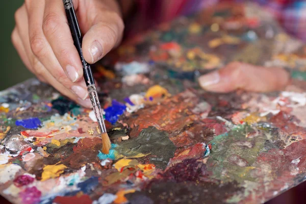 Hand Mixing Paint On Palette — Stock Photo © racorn #26899299