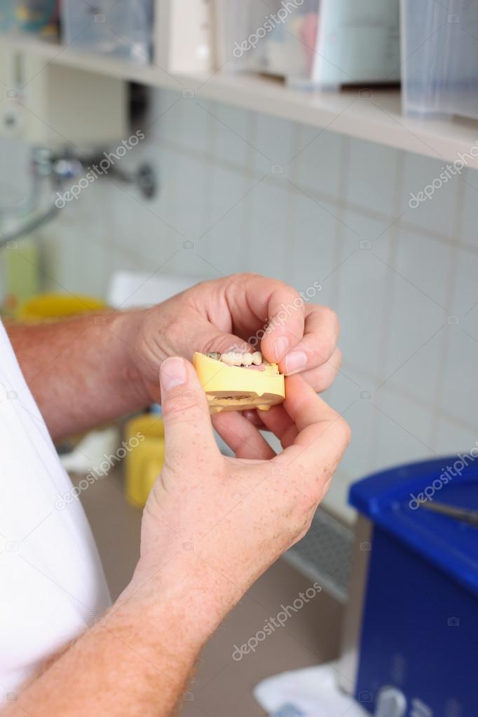 Dentist Checking Teeth Cast In Clinic — Stock Photo © racorn #26968591