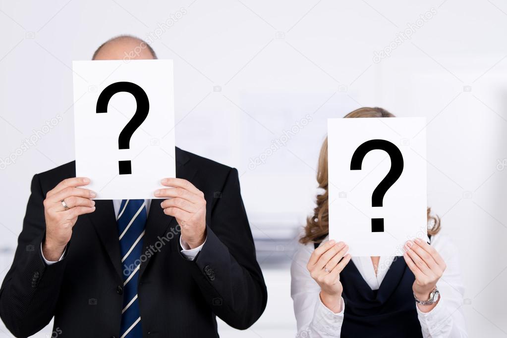 Businesspeople Holding Question Mark Signs On Placard In Front O ...