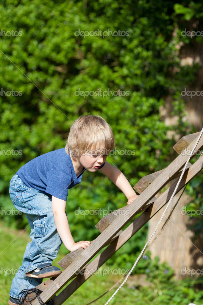 Boy Climbing Ladder In Playground Stock Photo by ©racorn 27210765