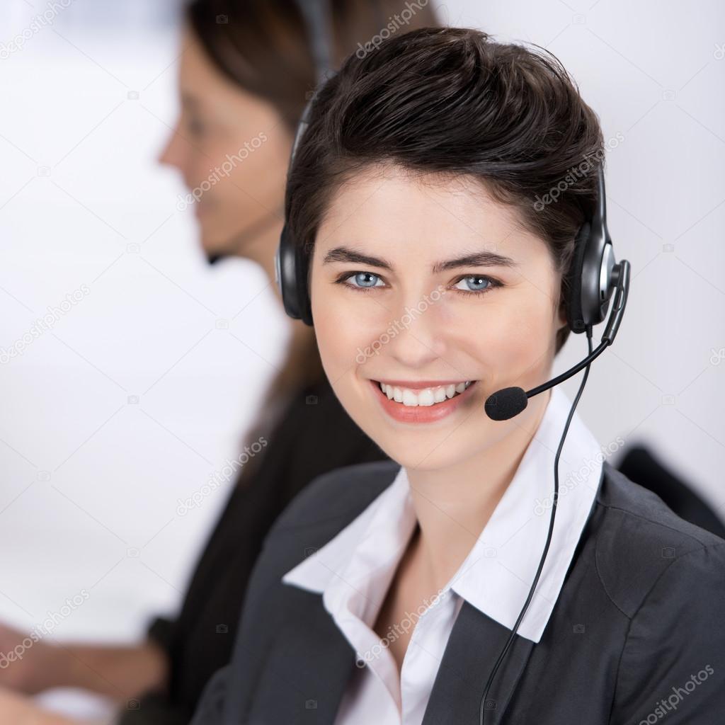 Customer Service Executive Wearing Headset With Coworker In Back Stock ...