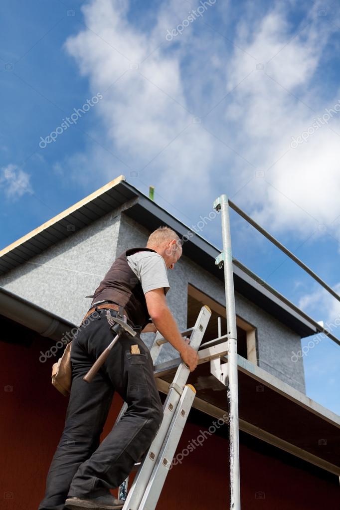 Roofer climbing a ladder into the scaffolding — Stock Photo © racorn ...