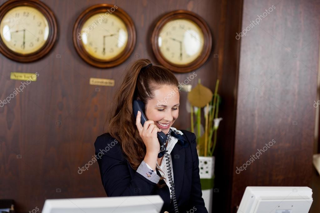 Smiling receptionist taking a telephone call Stock Photo by ©racorn ...
