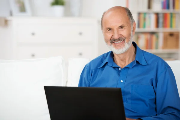 Confident elderly man using a laptop - Stock Image - Everypixel
