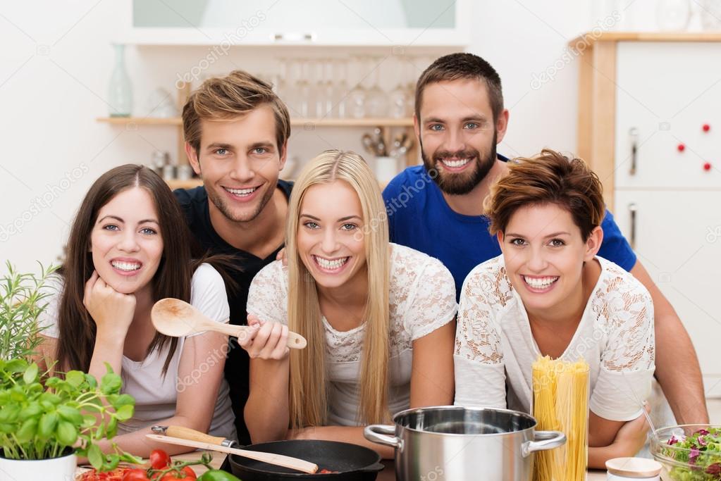 Smiling multicultural group of friends cooking — Stock Photo © racorn ...