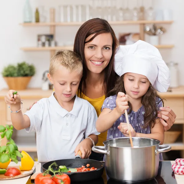 Young brother and sister learning to cook - Stock Image - Everypixel