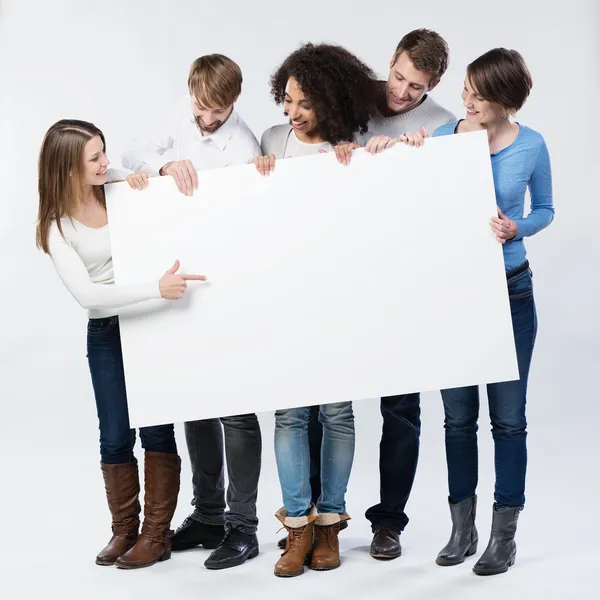 Group of young friends looking at a blank sign - Stock Image - Everypixel