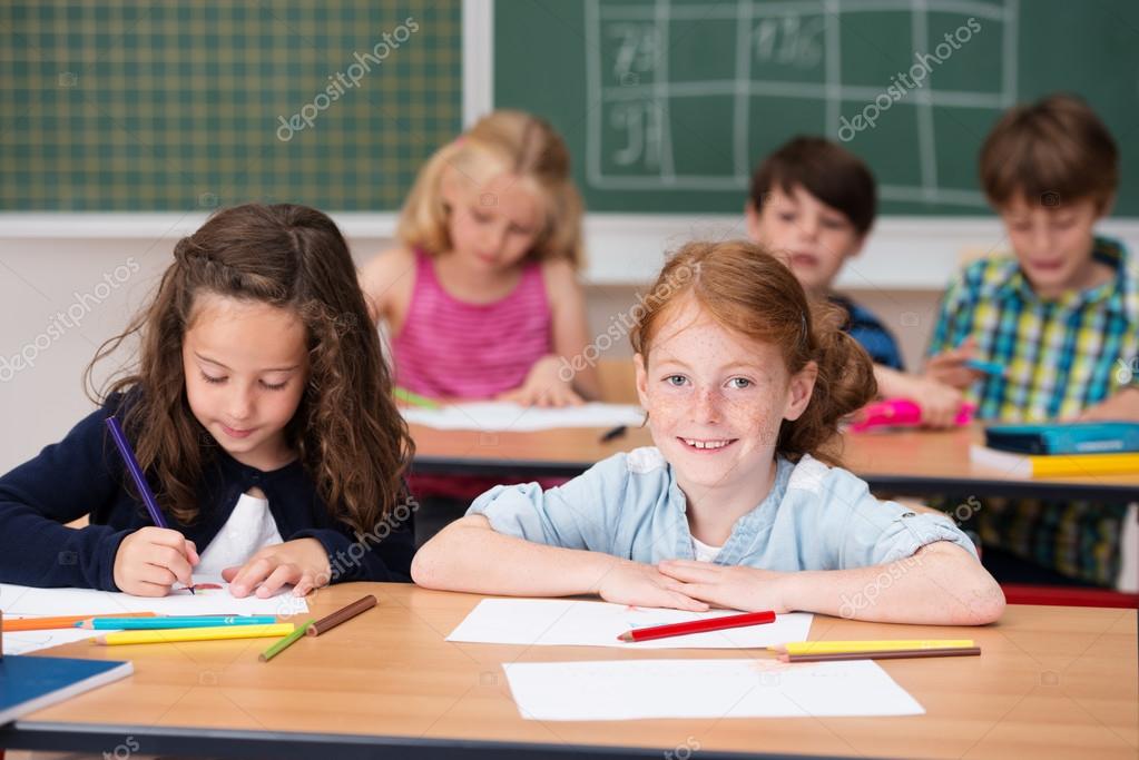 Smiling pretty redhead girl in class — Stock Photo © racorn #51325261