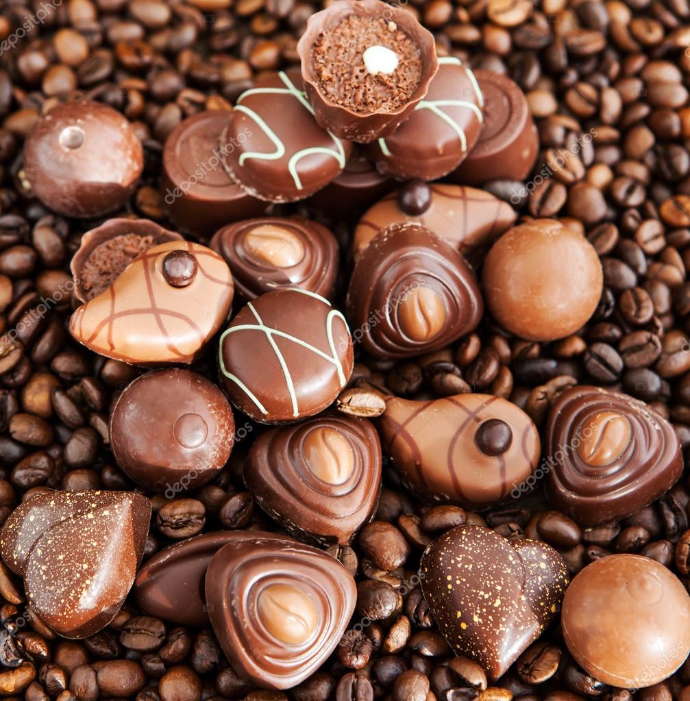 Assorted chocolate pralines on coffee beans background — Stock Photo ...