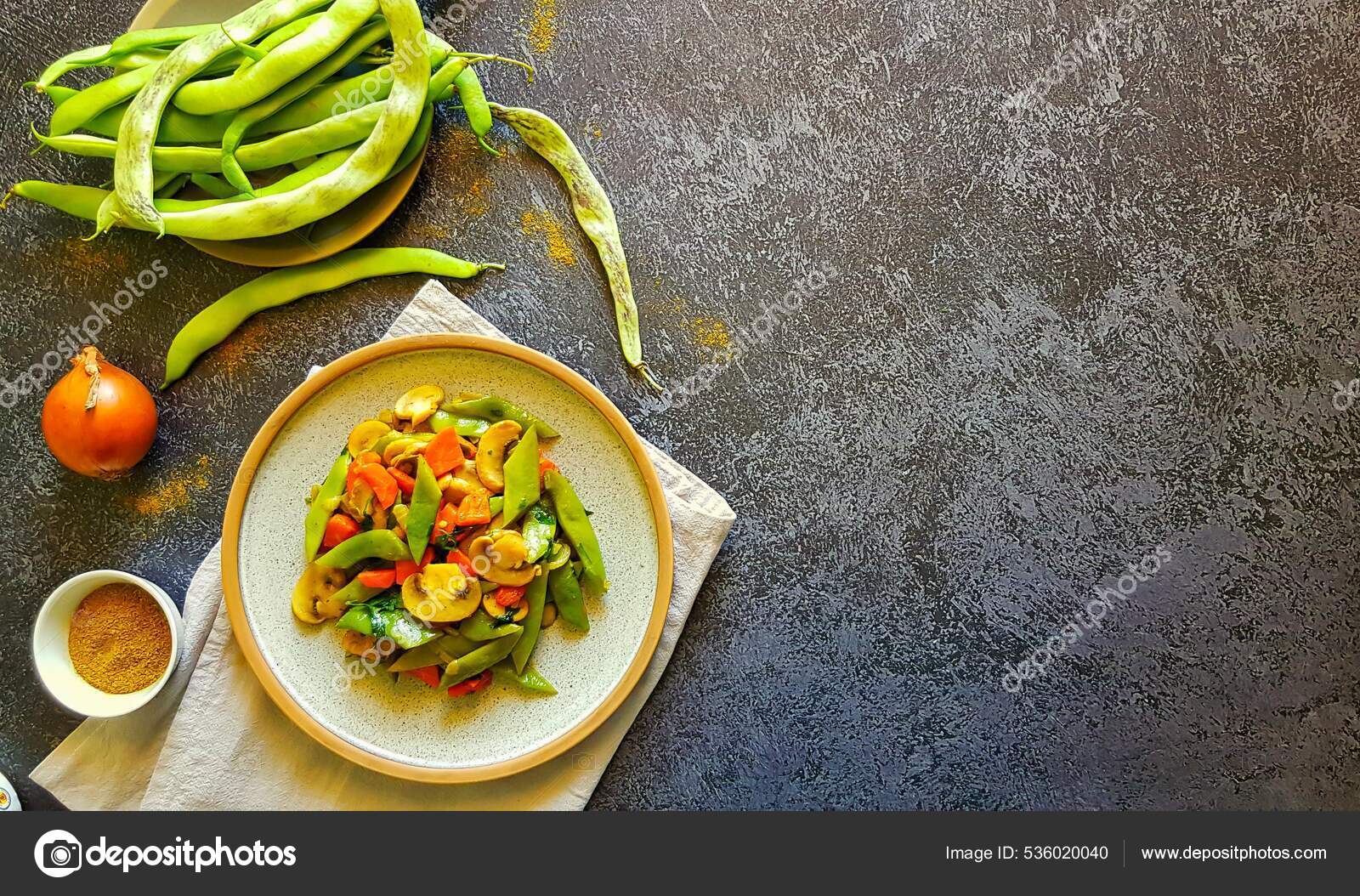 Stewed string beans with mushrooms, onions, carrots and olive oil on a ...