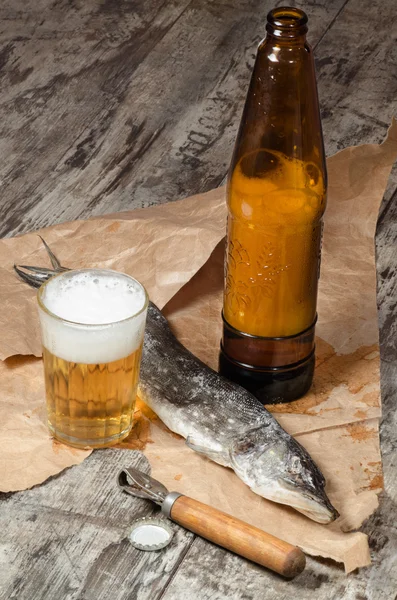 Dry fish with beer on wrapping paper - Stock Image - Everypixel
