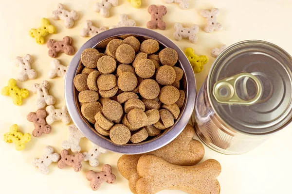 Top view of brown biscuit bones, crunchy organic kibble pieces and wet ...