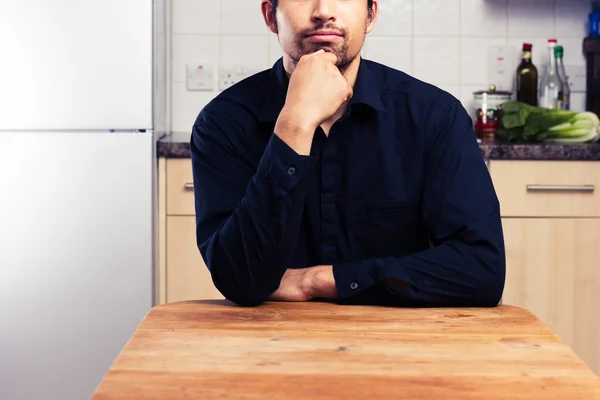 Overweight man sitting at kitchen table with eyes closed Stock Photo by ...
