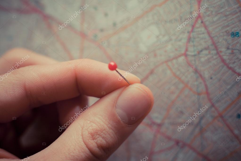 Hand placing pin pn map Stock Photo by ©lofilolo 41370685