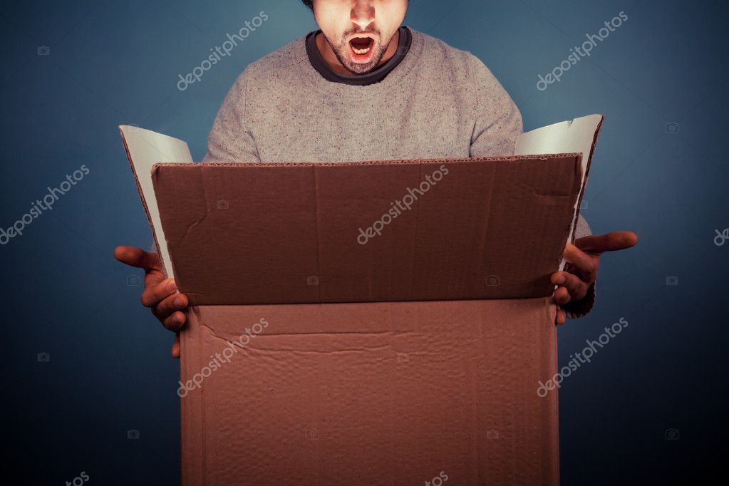 Surprised young man opening exciting box Stock Photo by ©lofilolo 42281073