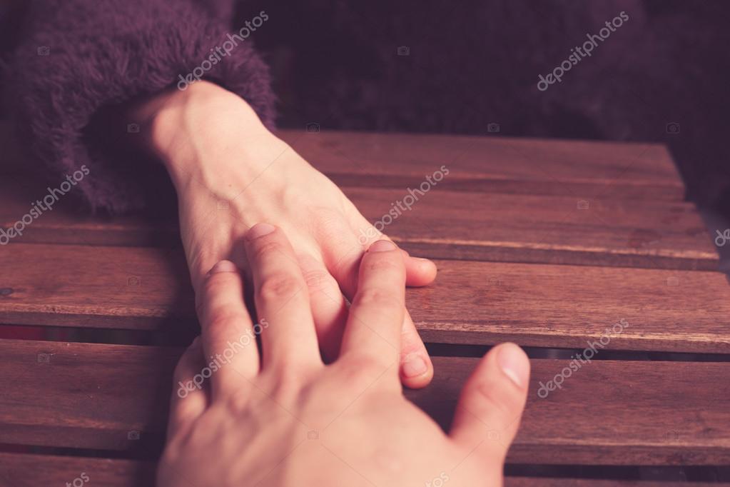 Couple's hands at table — Stock Photo © lofilolo #42282371