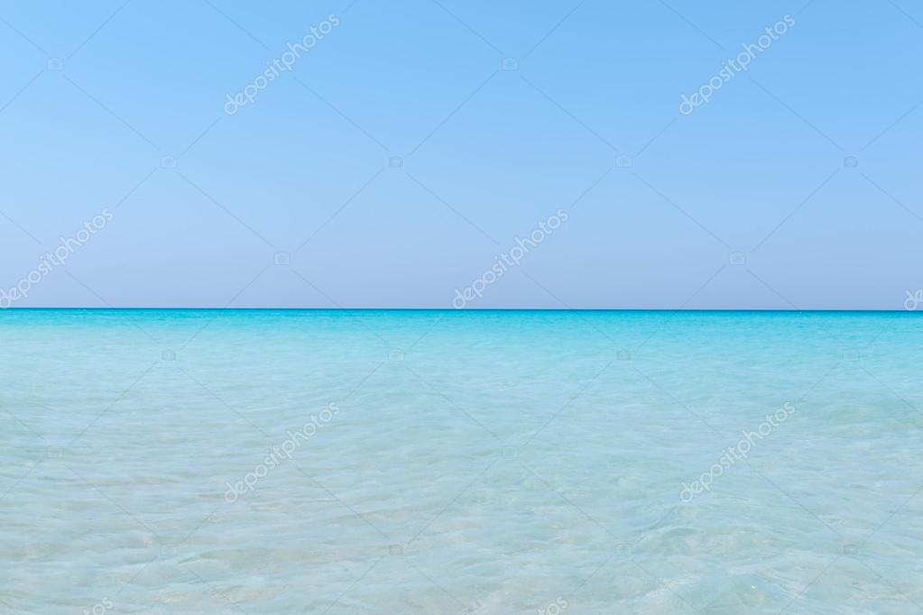 Turquoise tranquil ocean merging with clear beautiful sky at horizon ...