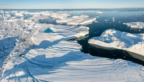 Climate change and global warming. Icebergs from a melting glacier in ...