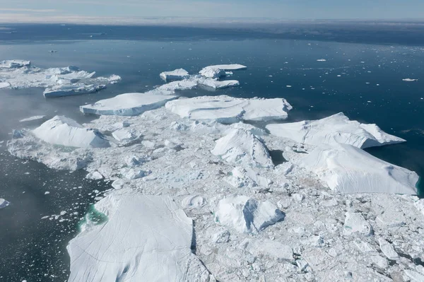 Climate change and global warming. Icebergs from a melting glacier in ...