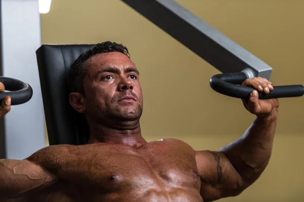 Male bodybuilder doing heavy weight exercise for upper chest - Stock ...