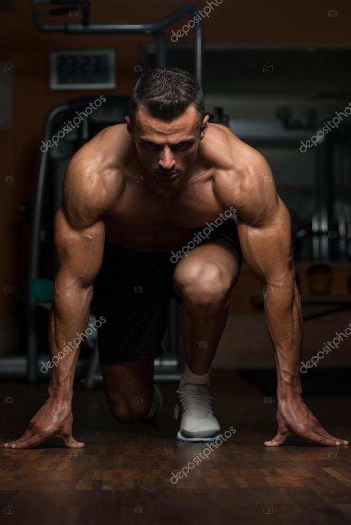 Strong Muscular Men Kneeling On The Floor — Stock Photo © ibrak #47292021