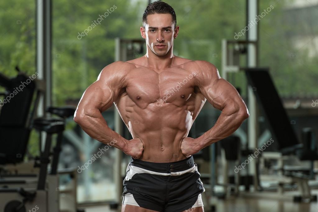 Muscular Men Flexing Muscles — Stock Photo © ibrak #48561915