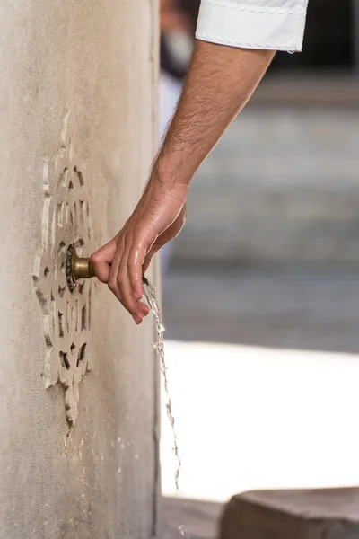 Muslim Washing Feet Before Entering Mosque - Stock Image - Everypixel